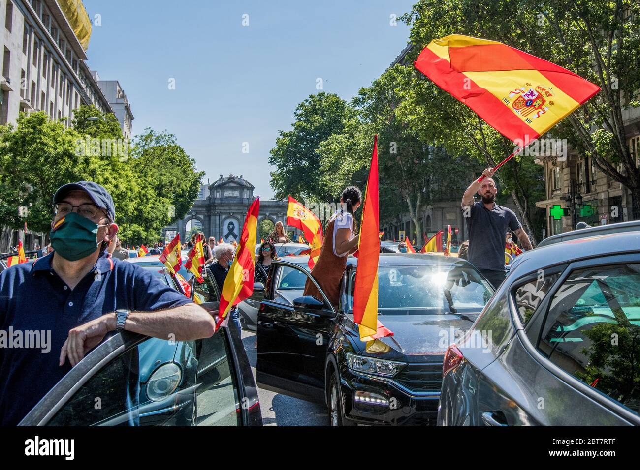 Protesters in cars wave Spanish flags during the demonstration ...