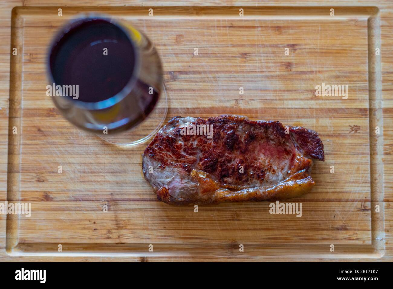 Shots of a sliced fresh rump steak with fat on the steak on a wooden ...