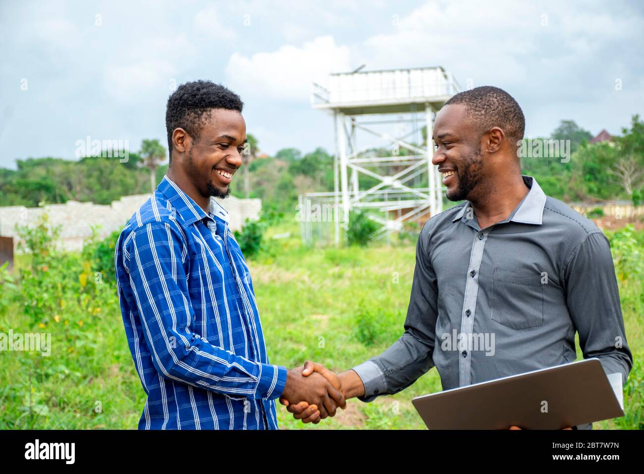 two african business men shake hands, smiling Stock Photo - Alamy