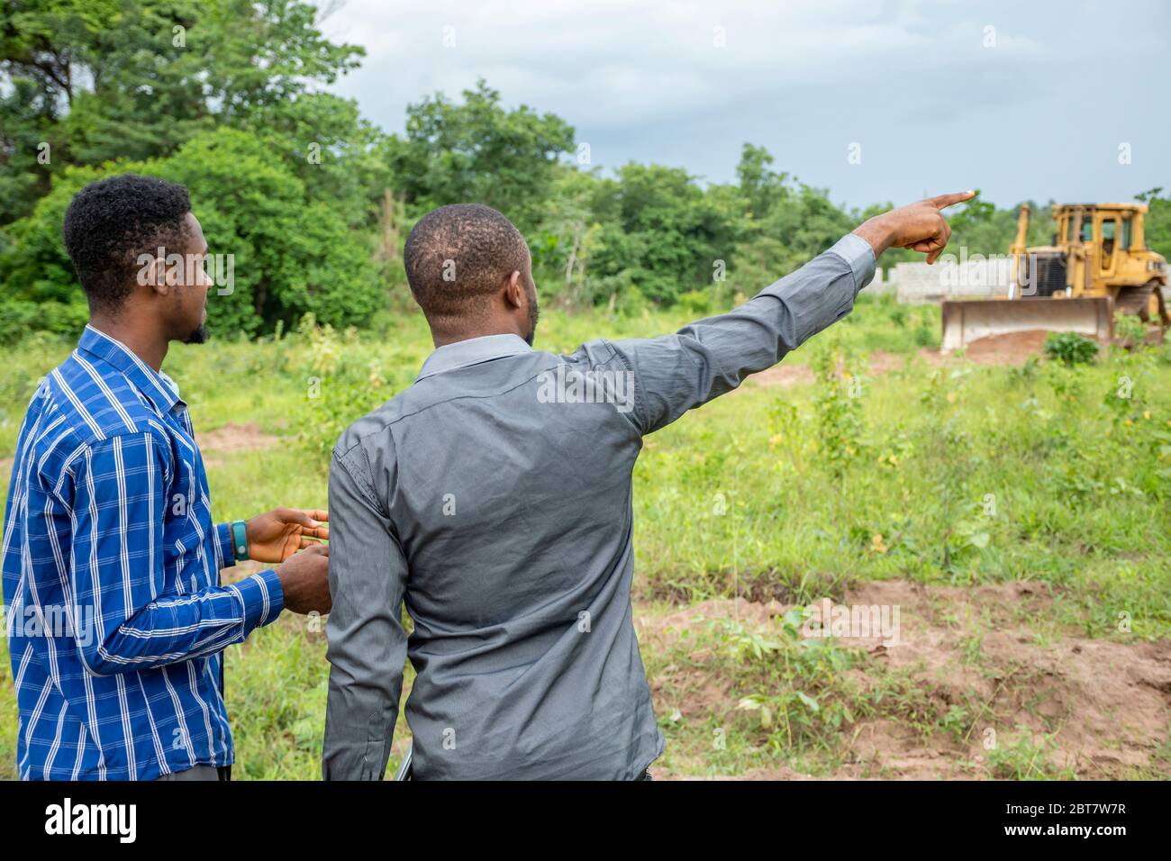 two young african men, surveying a piece of land Stock Photo - Alamy