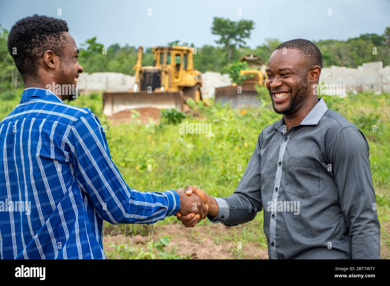 two young african modern farmers shake hands, smiling Stock Photo - Alamy