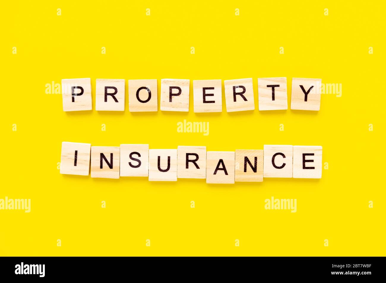 words property insurance. Wooden blocks with lettering on top of yellow ...