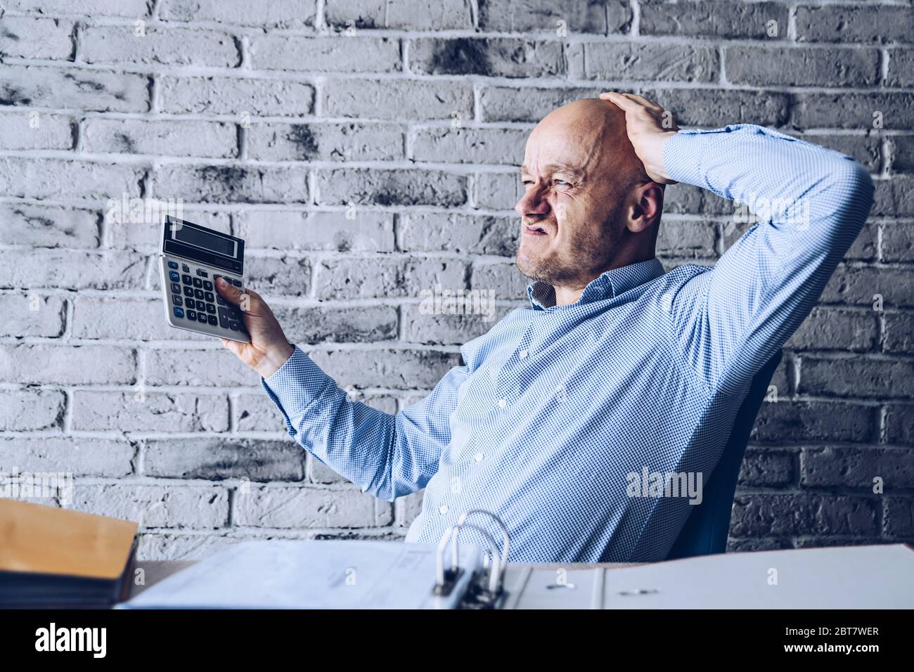 Finance problems and crisis. Worried manager in the office counting ...