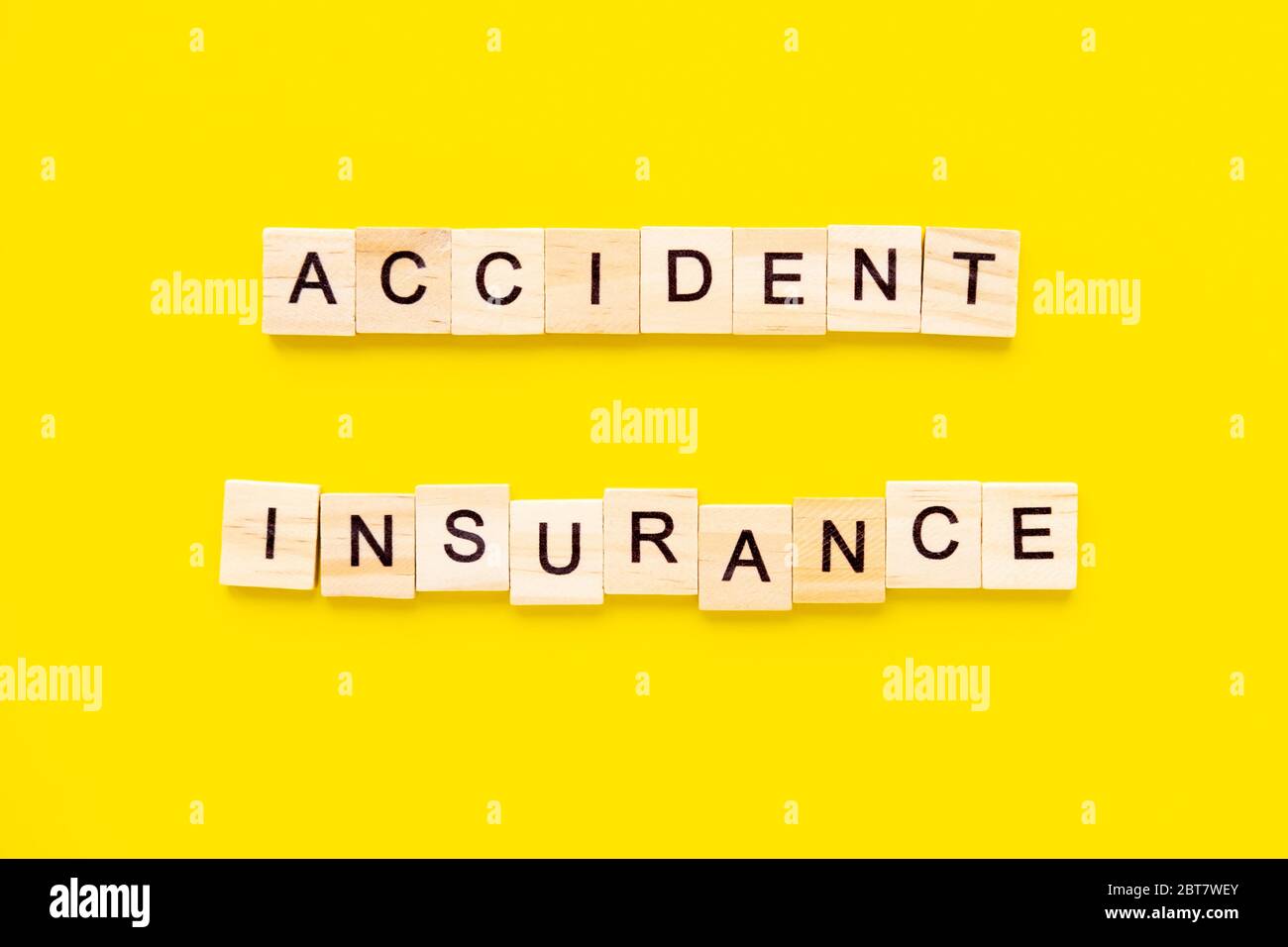 words accident insurance. Wooden blocks with lettering on top of yellow ...