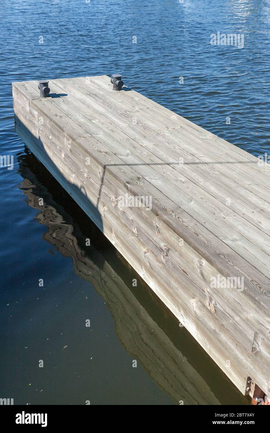 long wooden pier at river closeup mooring posts Stock Photo - Alamy