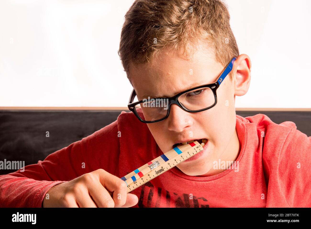 Boy learning at home with pen and ruler Stock Photo - Alamy
