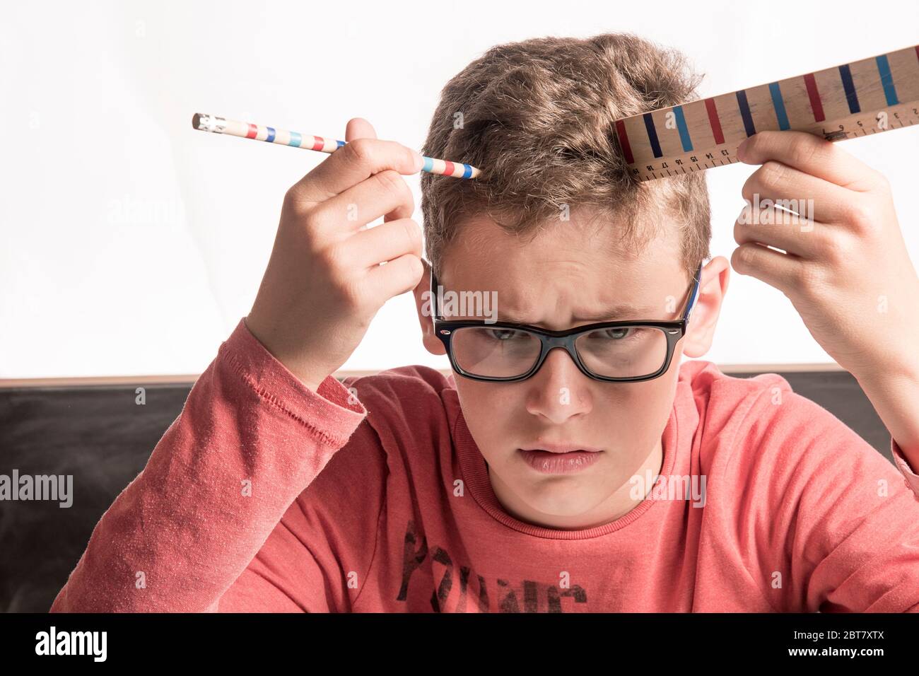 Boy learning at home with pen and ruler Stock Photo - Alamy