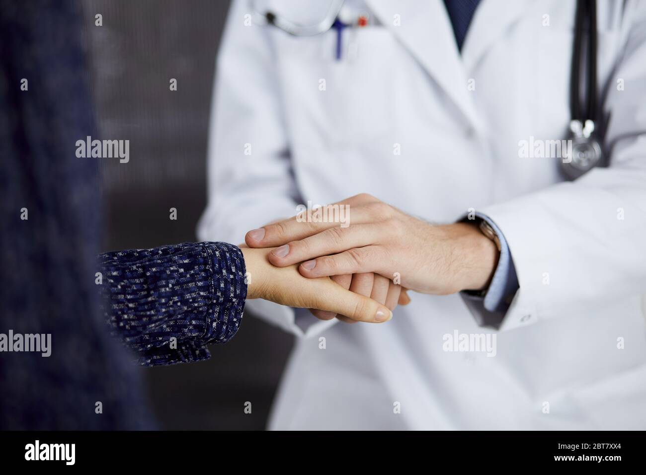 Friendly red-beard doctor reassuring his female patient, close-up ...