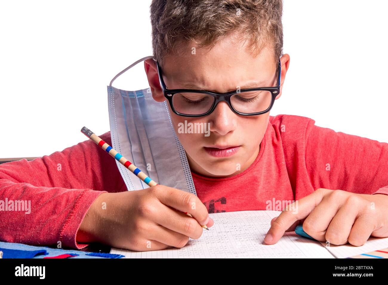 Stressed learning of a boy while writing in the math notebook Stock ...