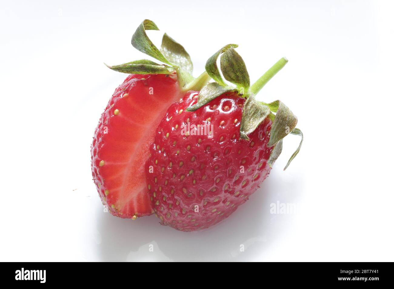 Fresh red strawberry cut in half on a white background. Healthy food ...