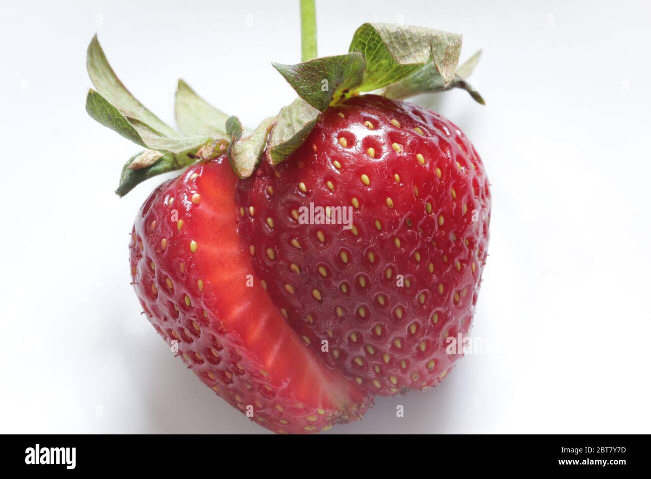 Fresh red strawberry cut in half on a white background. Healthy food ...