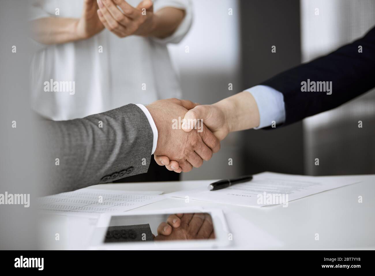 Business people shaking hands finishing contract signing, close-up ...