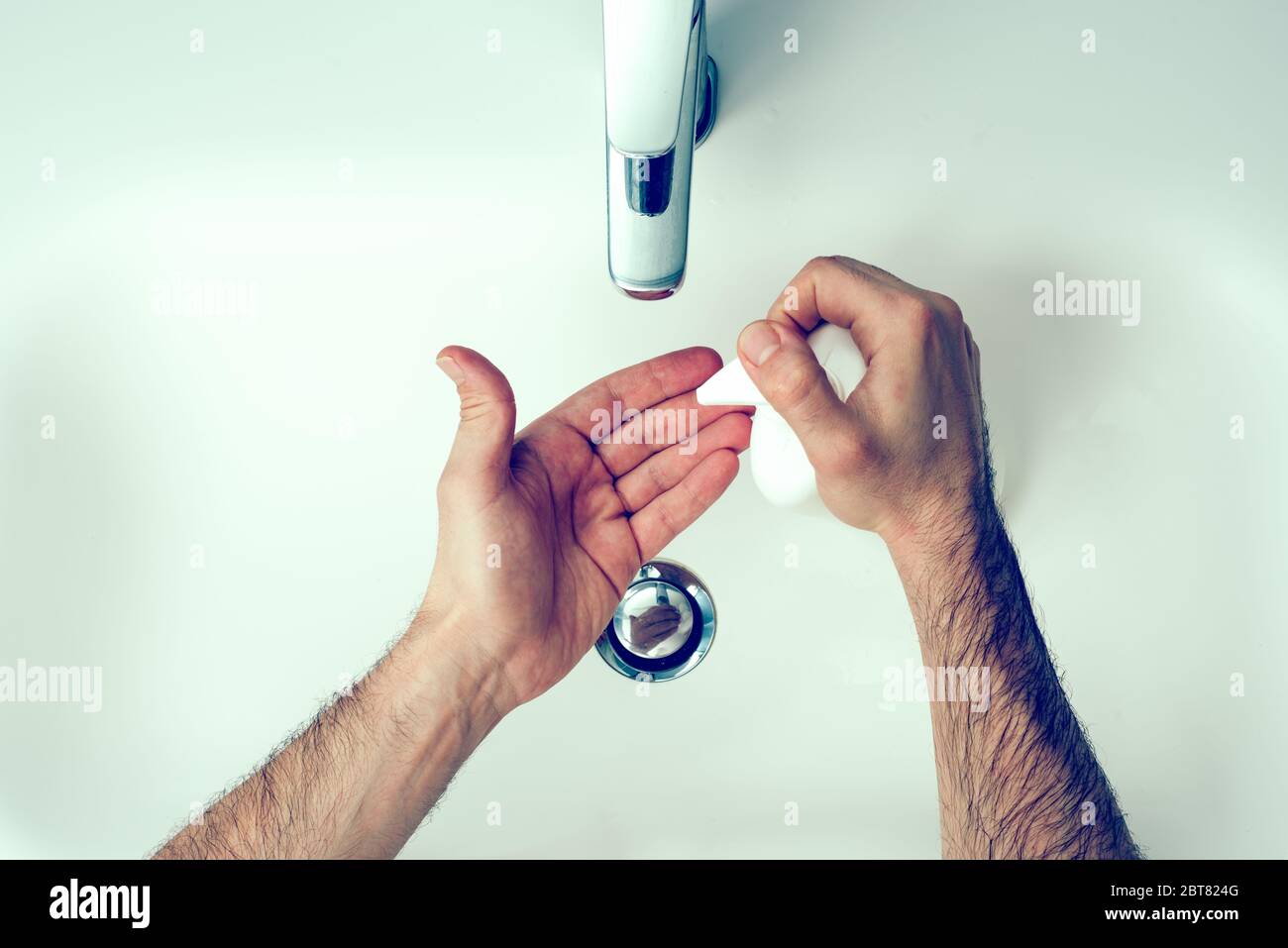man washing the hands in the bathroom, pushing dispenser, cleanin g ...
