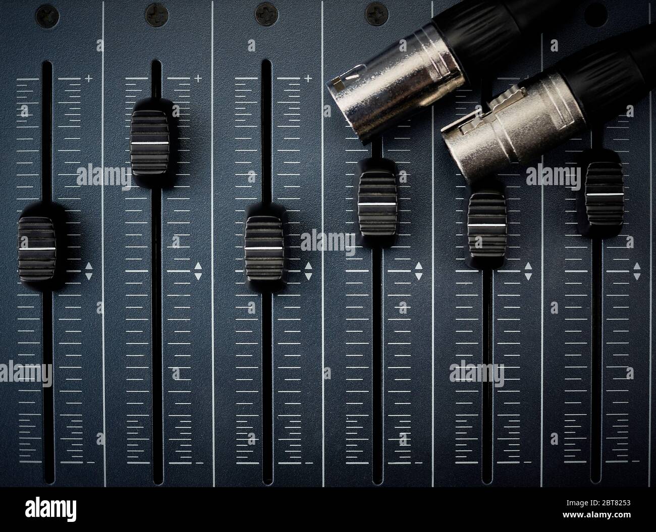 Audio mixer with foreground faders and audio cables with xlr connectors ...