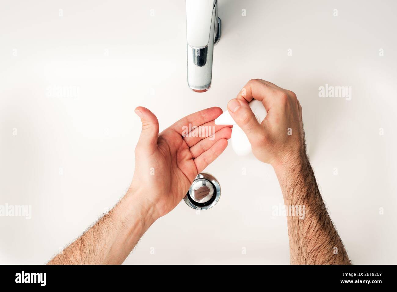 man washing the hands in the bathroom, pushing dispenser, cleanin g ...