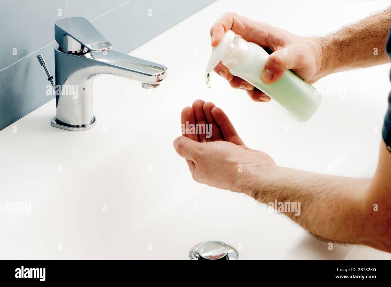 man washing the hands in the bathroom, pushing dispenser, cleanin g ...