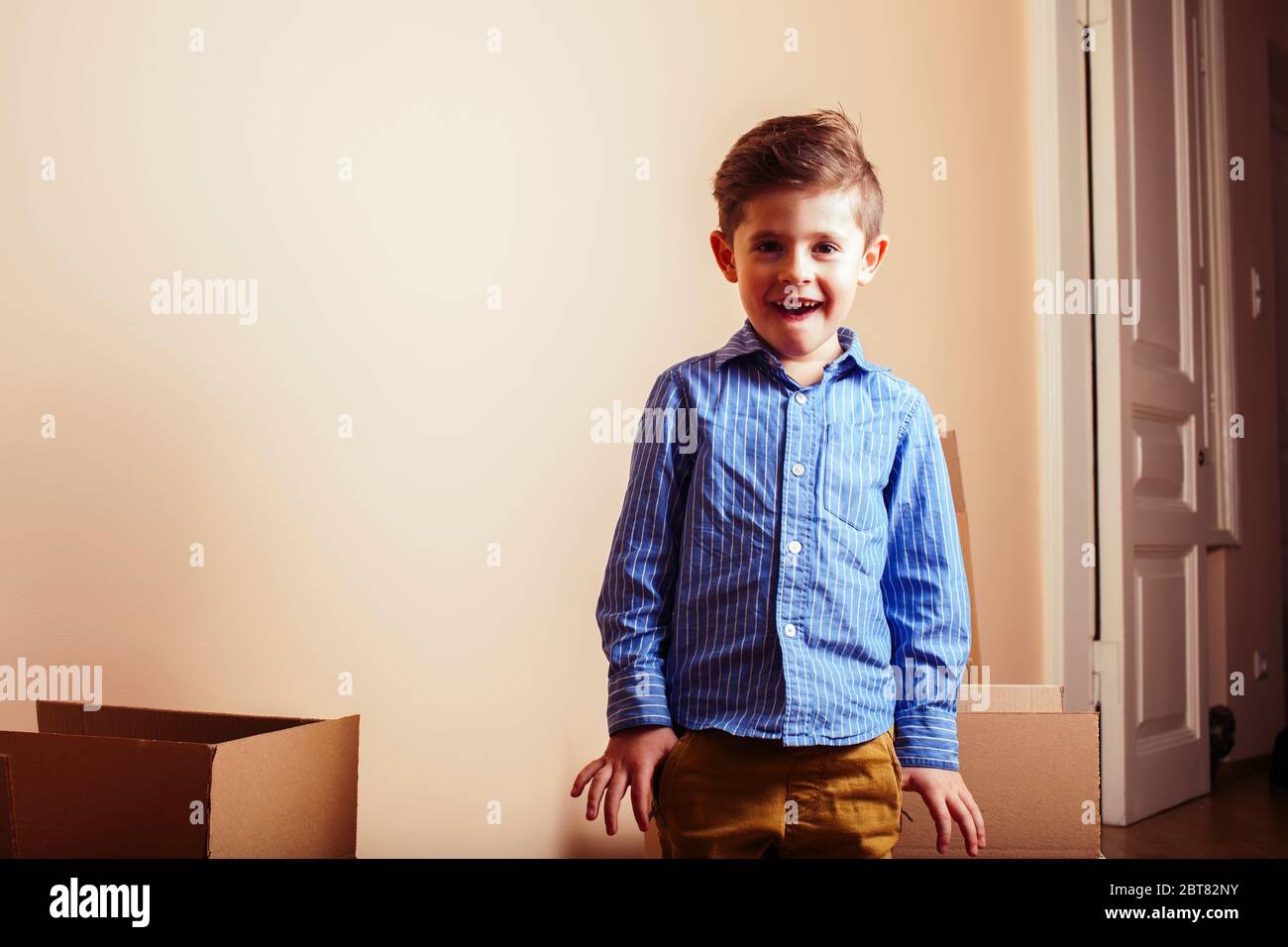 little cute boy in empty room, move to new house. home alone among ...