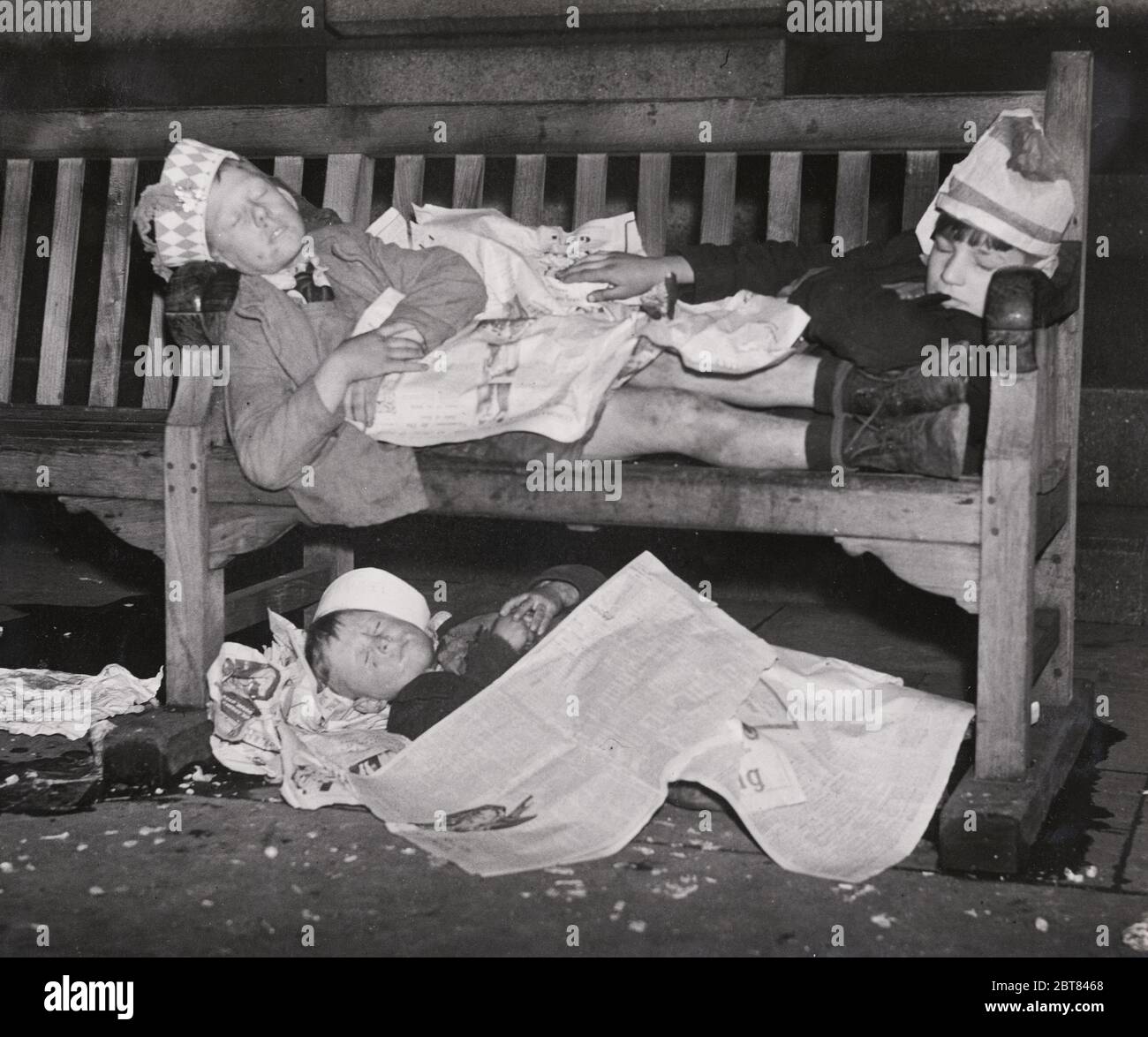 Boys sleeping on a park bench, waiting for the coronation procession of ...