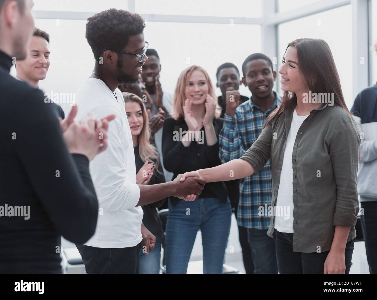 group of happy young people congratulating their colleague Stock Photo ...