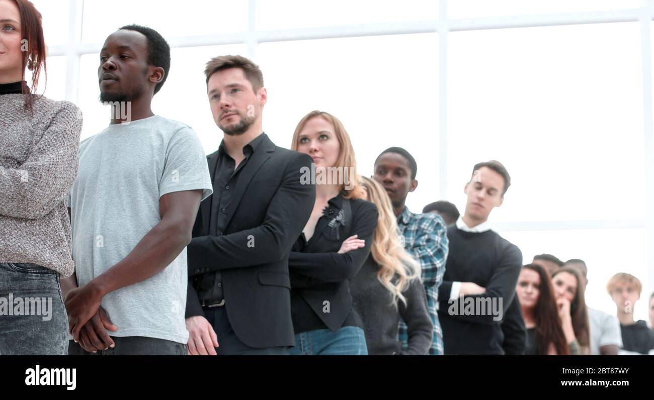 group of serious young people standing in line Stock Photo - Alamy