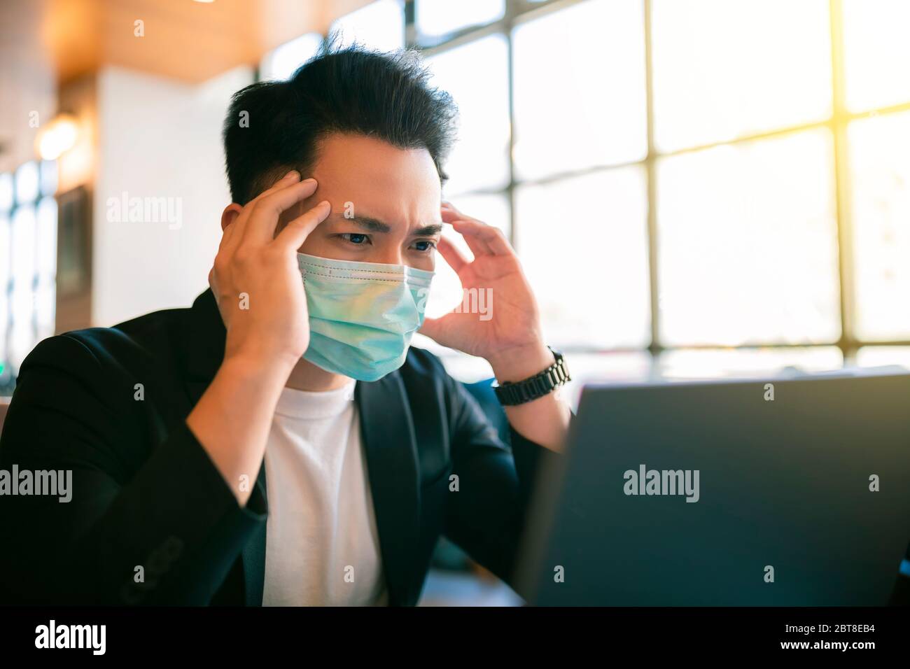 yuoung Business man wear mask and working in office Stock Photo - Alamy