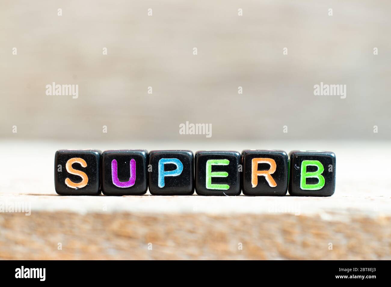 Black bead with color letter in word superb on wood background Stock ...