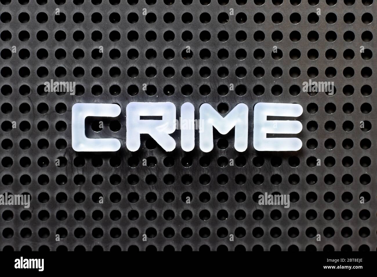 White color alphabet with word crime on black pegboard background Stock ...