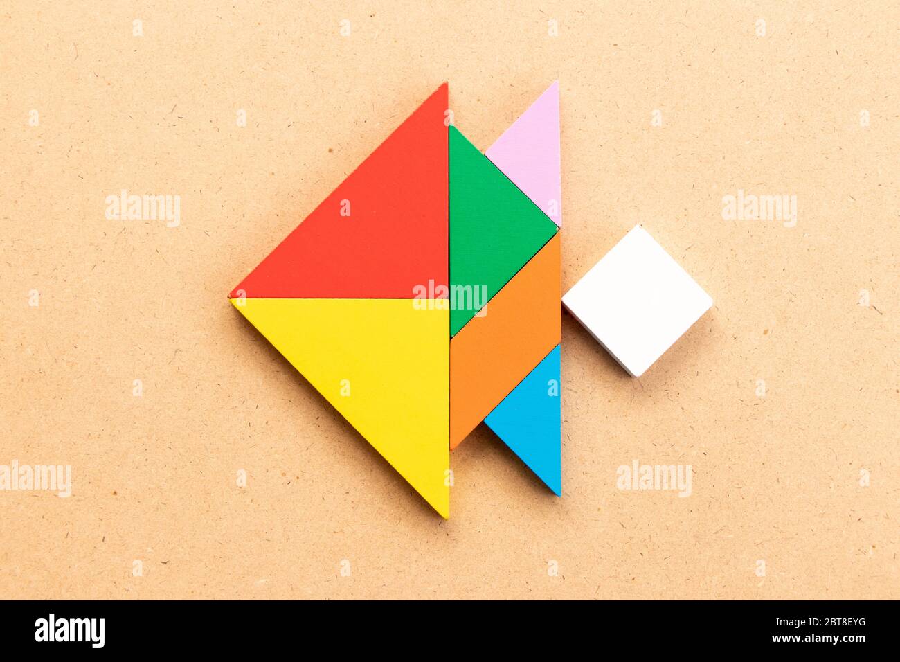 Color tangram puzzle in fish shape on wood bacground Stock Photo - Alamy