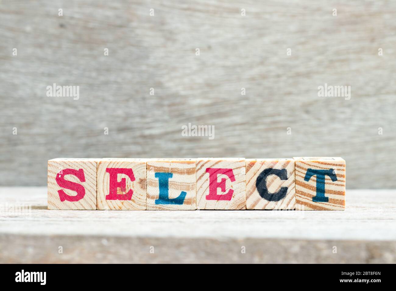Letter block in word select on wood background Stock Photo - Alamy