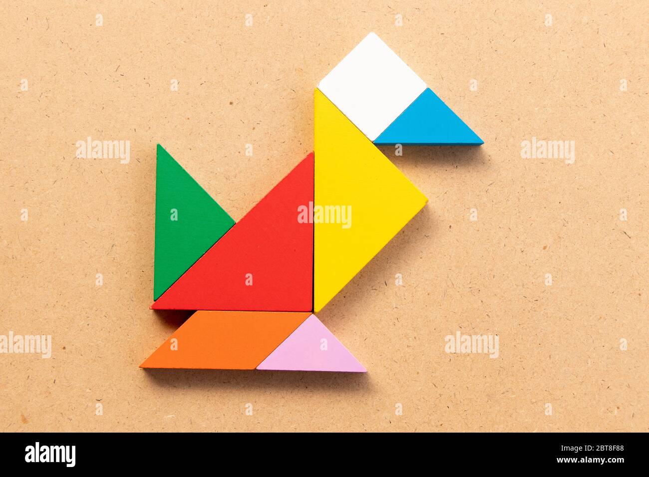 Color tangram puzzle in bird or duck shape on wood bacground Stock ...