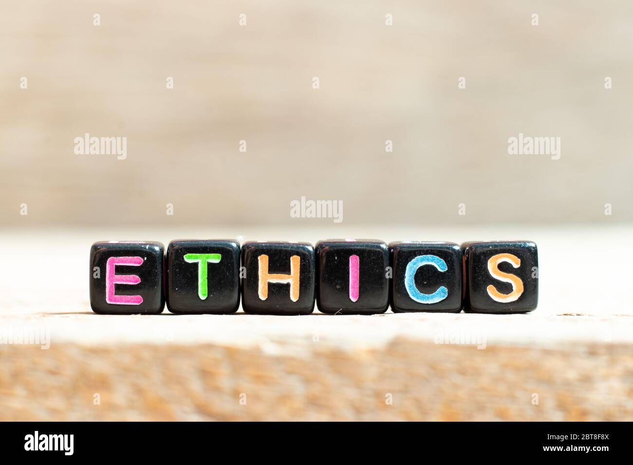 Black bead with color letter in word ethics on wood background Stock ...