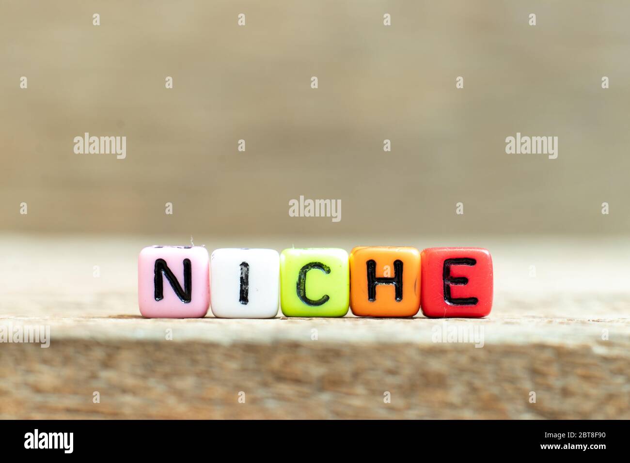 Colorful bead with black letter in word niche on wood background Stock ...