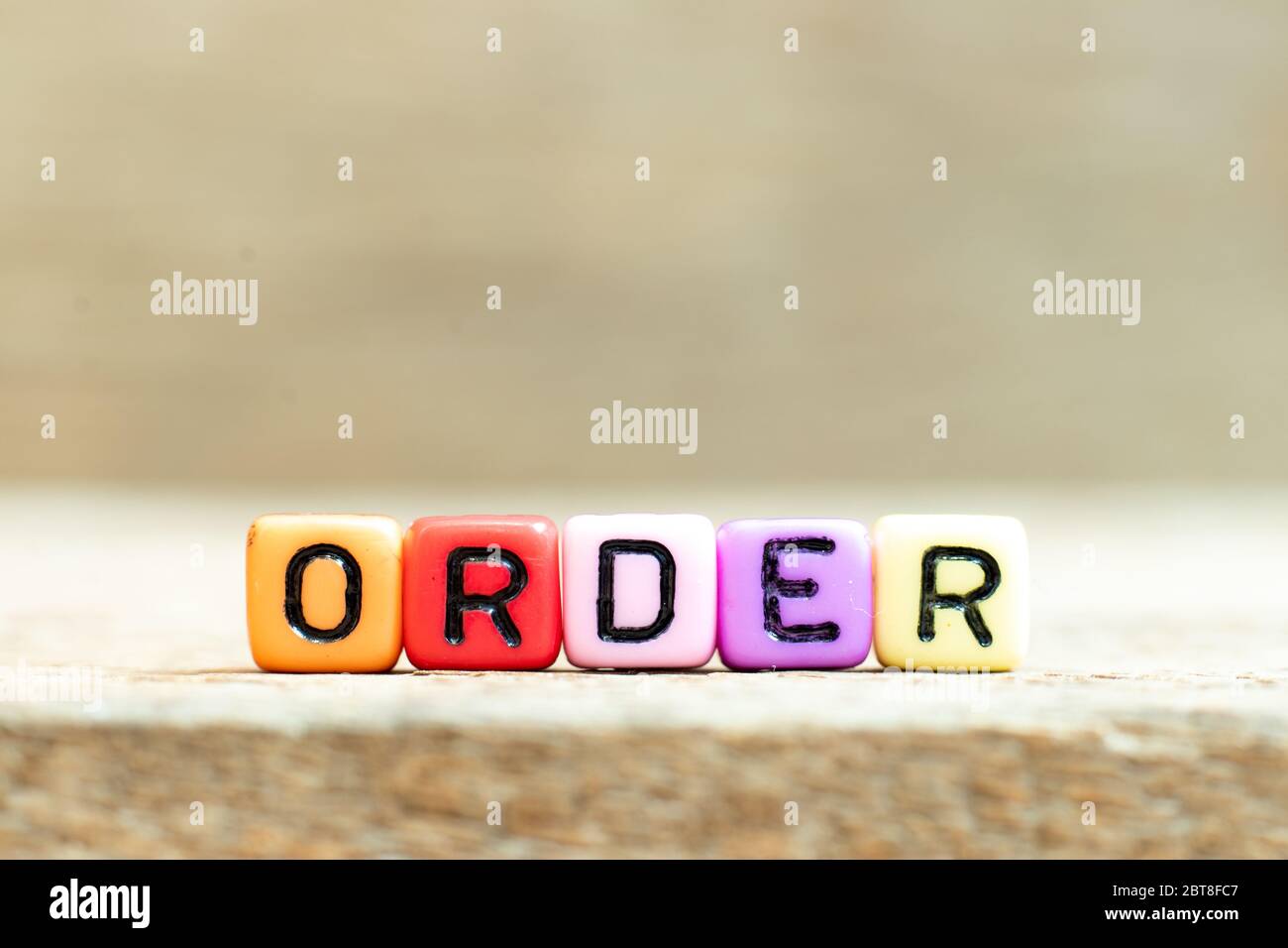Colorful bead with black letter in word order on wood background Stock ...