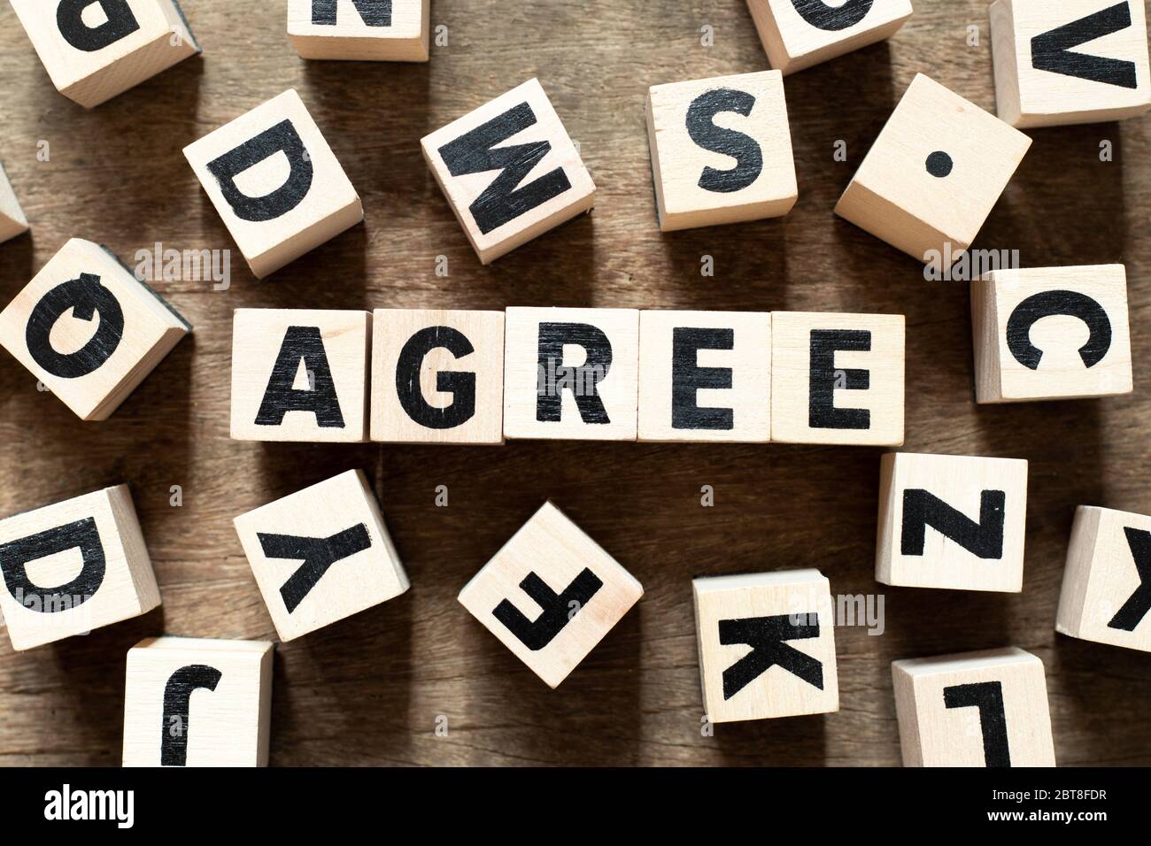 Wood letter block in word agree on wood background with another ...