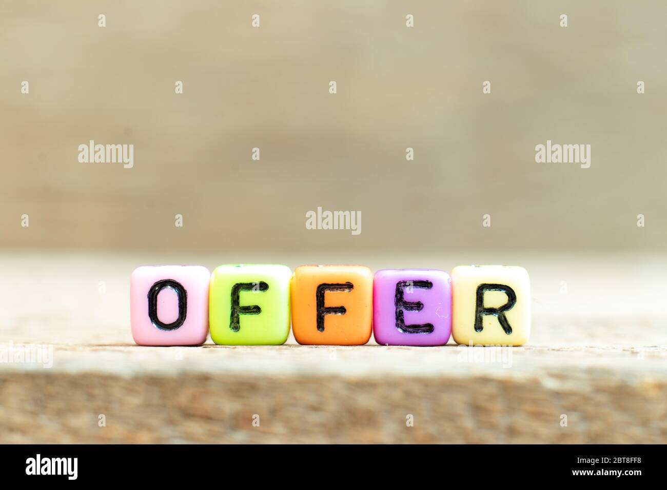Colorful bead with black letter in word offer on wood background Stock ...