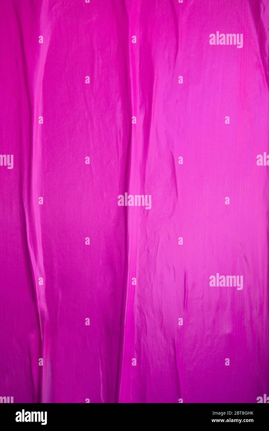Pink gued sheet of paper with air pockets and wrinkles Stock Photo - Alamy