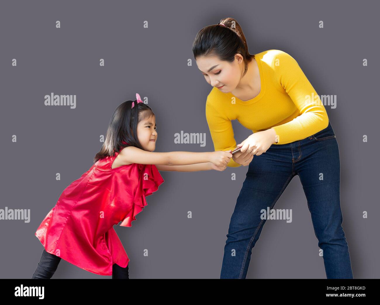 kid and mom figth over for scramble mobile phone. mobile addict concept ...