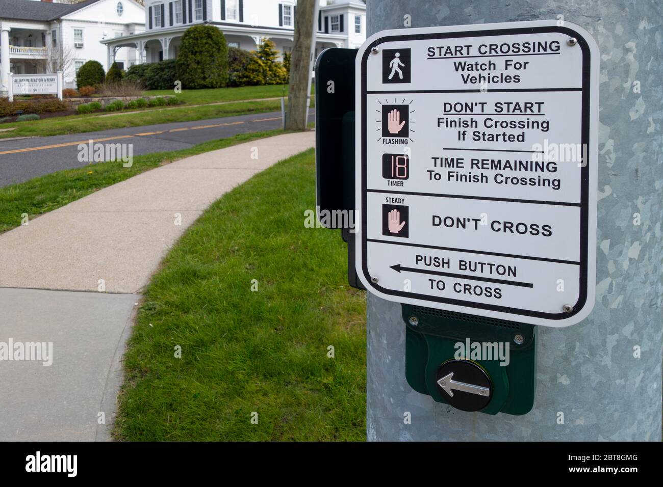 street corner walkway sign with arrow crossing Push button Stock Photo ...