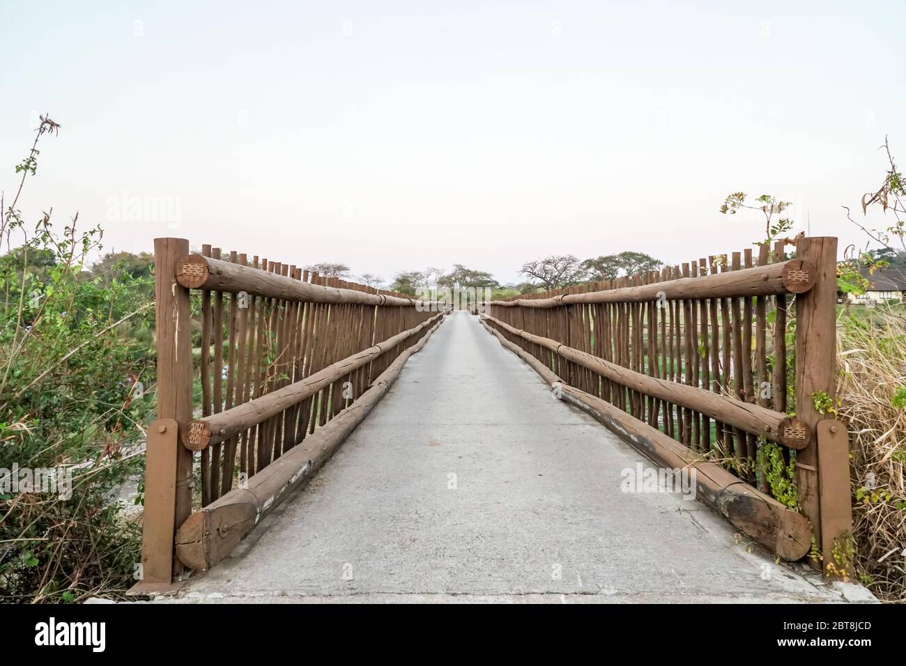 rustic bridge or walkway over a river in rural South Africa with wooden ...