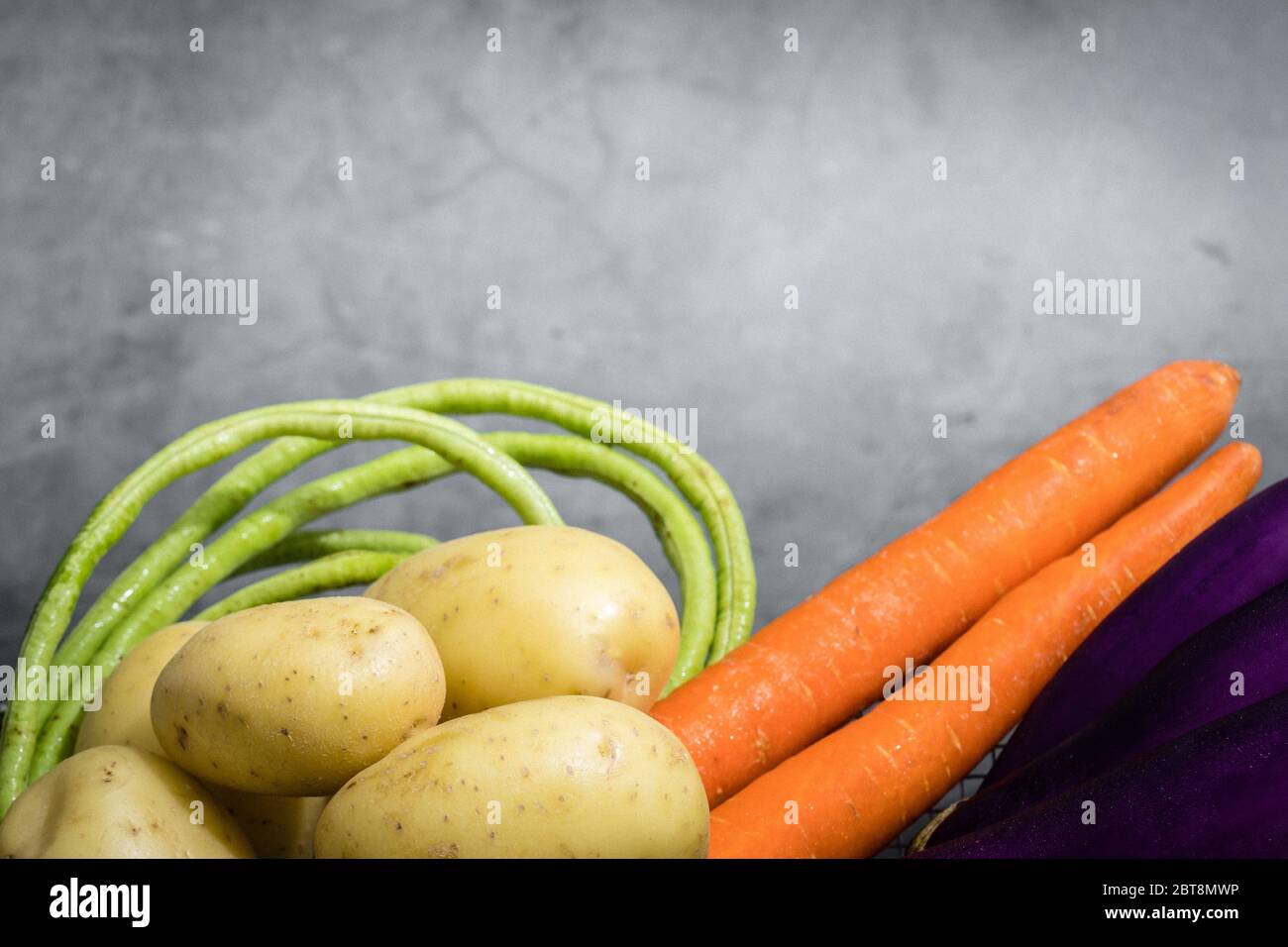 Assorted raw organic vegetables on grey background Stock Photo - Alamy