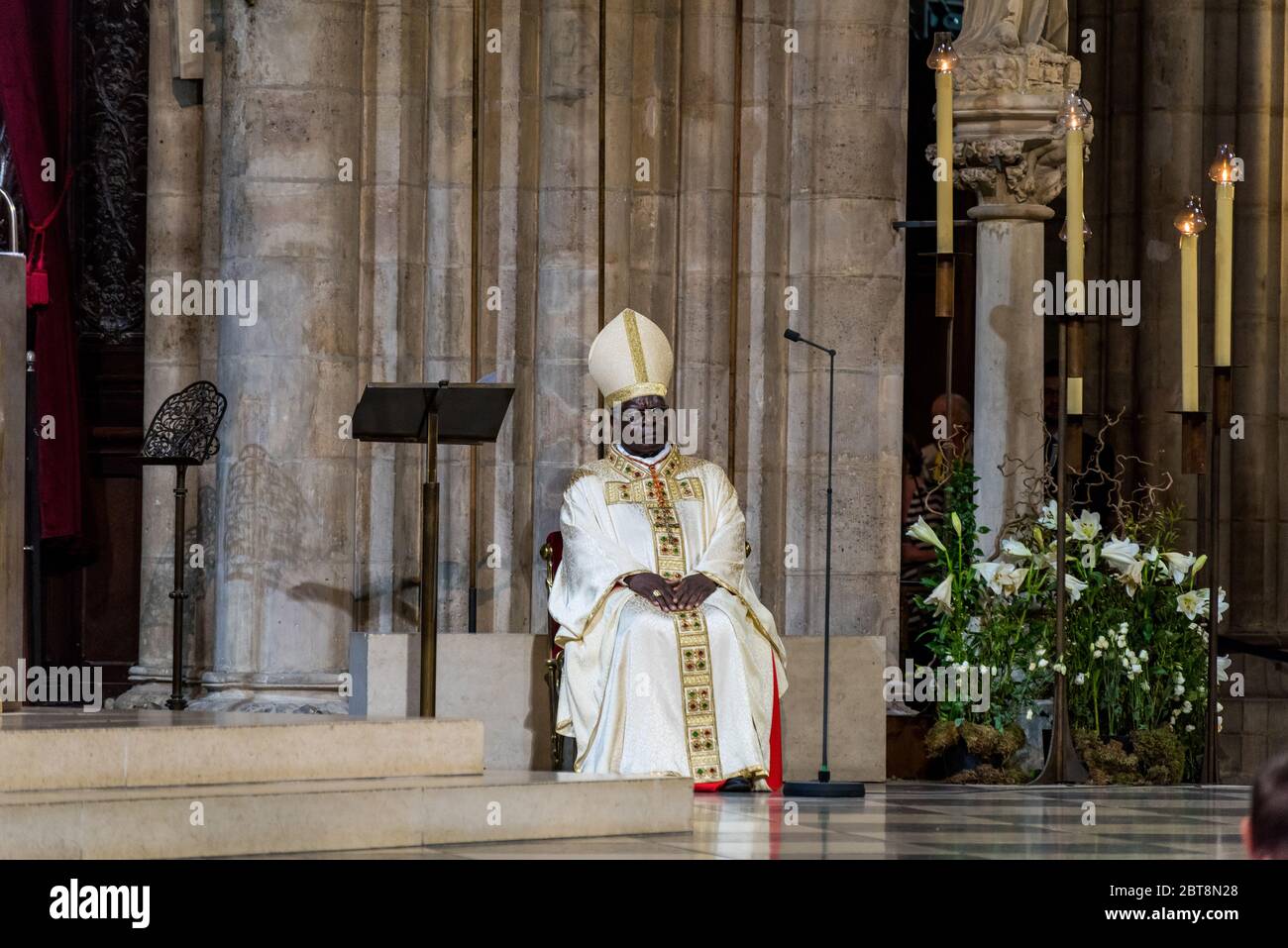 A priest sitting at the Notre-Dame de Paris before the big fire, a ...