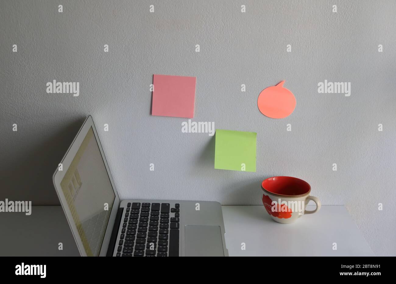 Closeup and selective focus on blank sticky notes attached to the wall ...