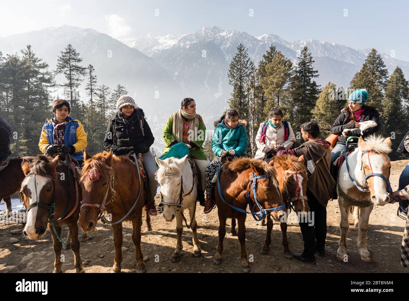 Tourists take a horse ride at the popular hill station of Pahalgam in Kashmir Stock Photo - Alamy
