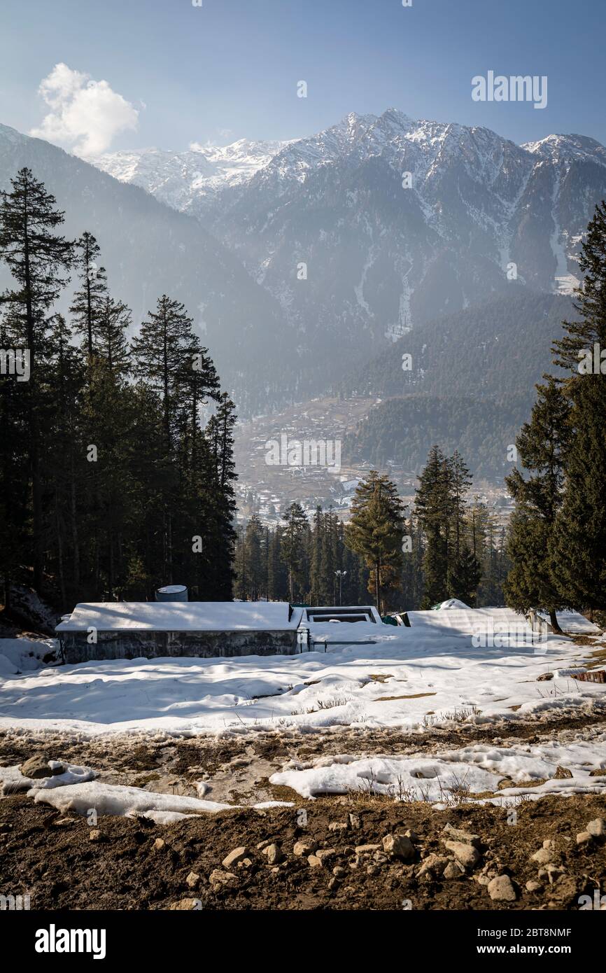 View of a snow covered house in the famous hill station of Pahalgam in ...