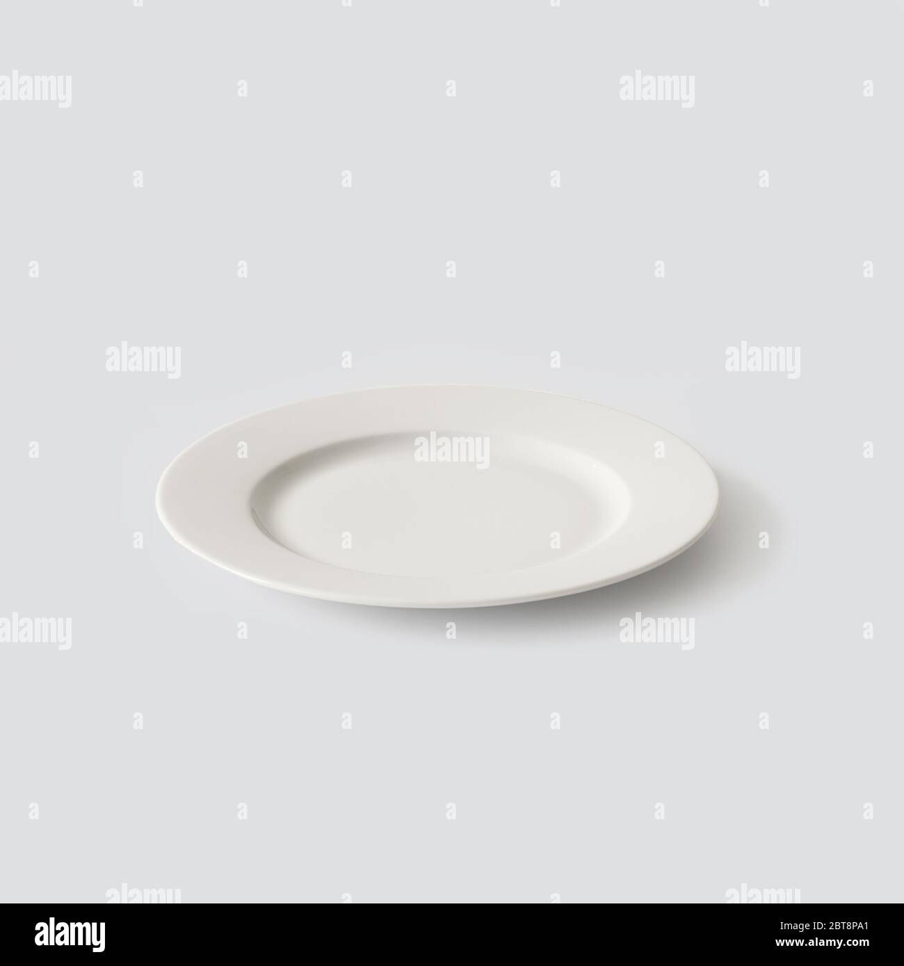 empty white plate isolated on light grey background Stock Photo - Alamy