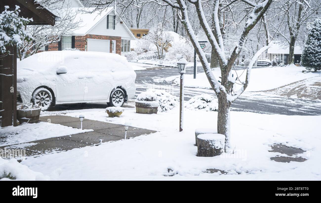 A landscape covered with snow during a snowfall at a residential ...