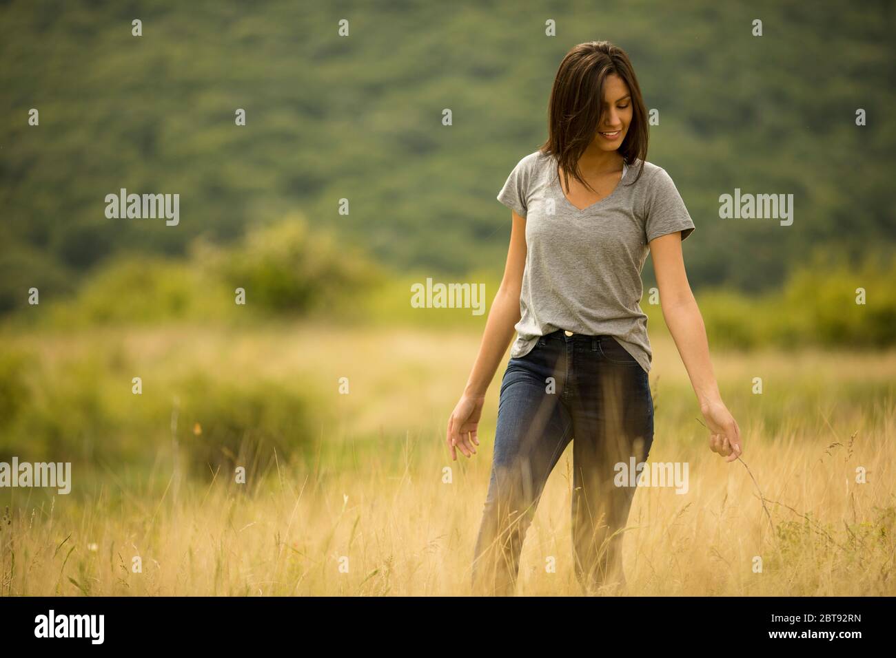 Woman walking in the field hi-res stock photography and images - Alamy