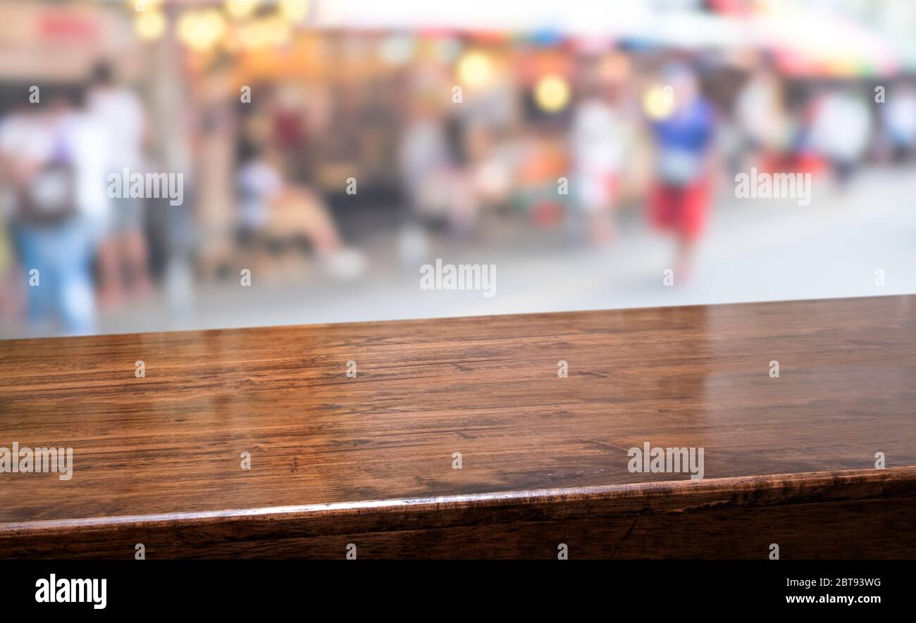 market background.Empty diagonal wood table with blur people shopping ...