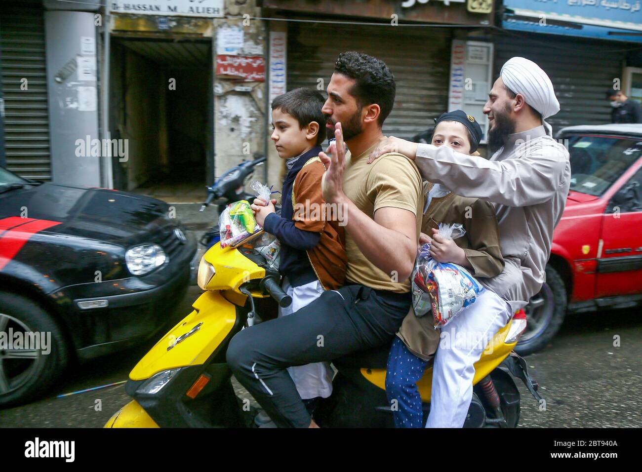 Beirut, Lebanon. 24th May, 2020. A Lebanese family ride on a motorcycle ...