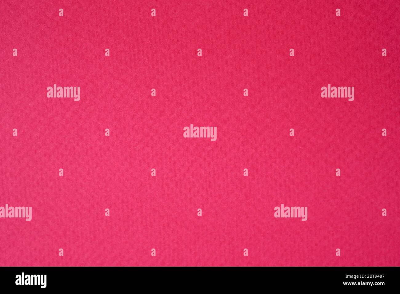 blurred pink paper background. Texture of colored cardboard top view ...